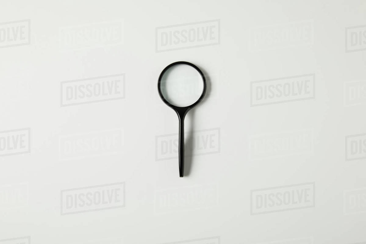 Top view of single black magnifying glass with handle isolated on grey ...