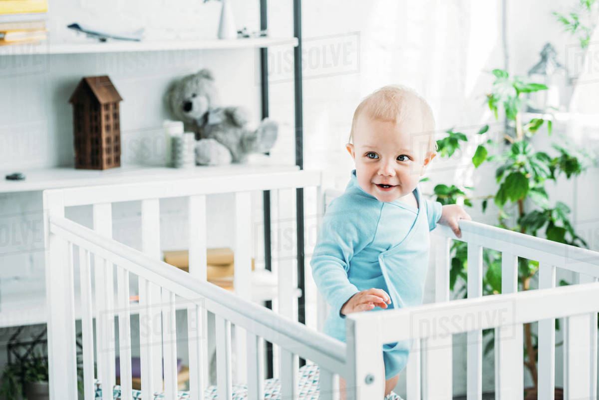 Happy little baby standing in crib at home - Royalty-free Stock Photo ...