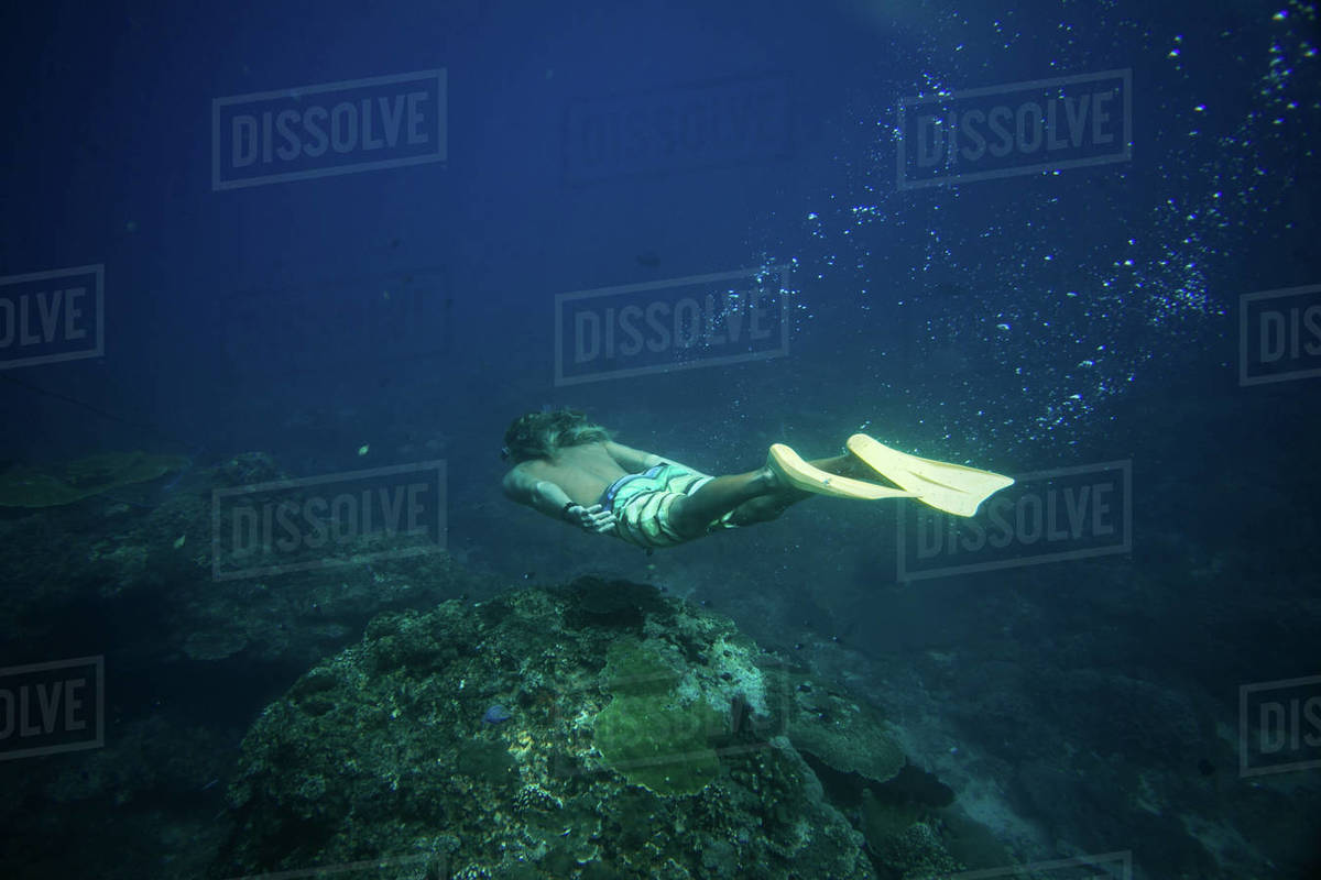 Side view of man in flippers diving in ocean alone - Royalty-free Stock ...