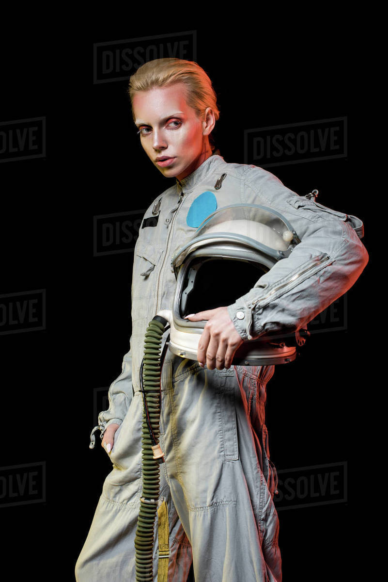 Beautiful female astronaut in spacesuit with helmet, isolated on black ...