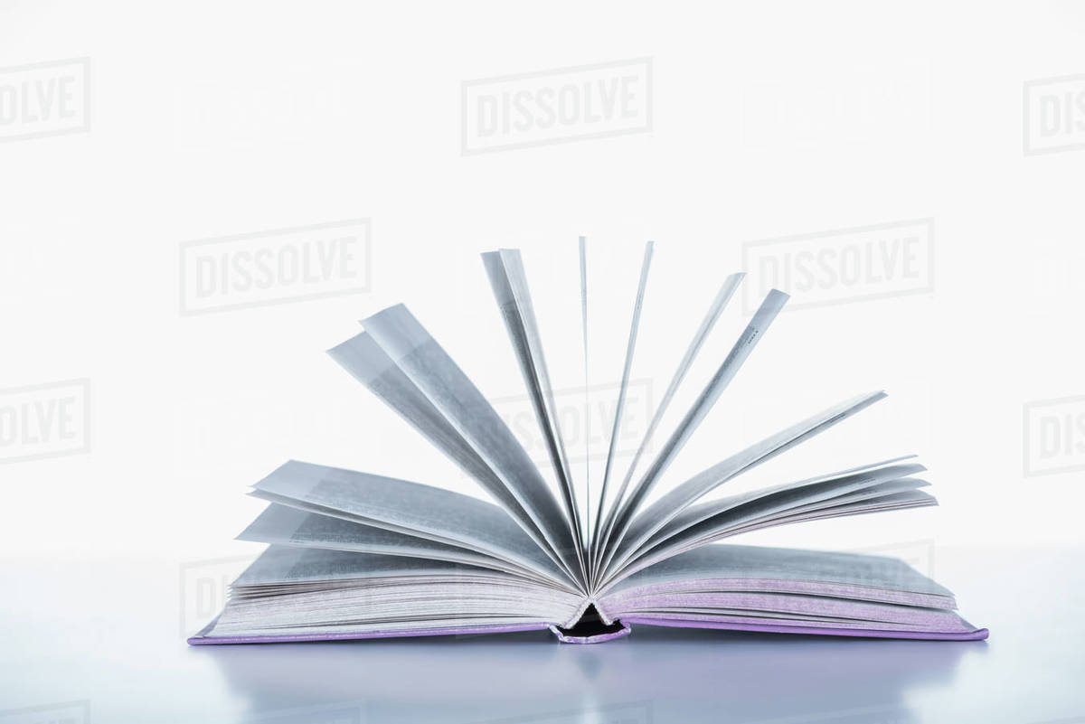 One open book on white surface - Royalty-free Stock Photo | Dissolve