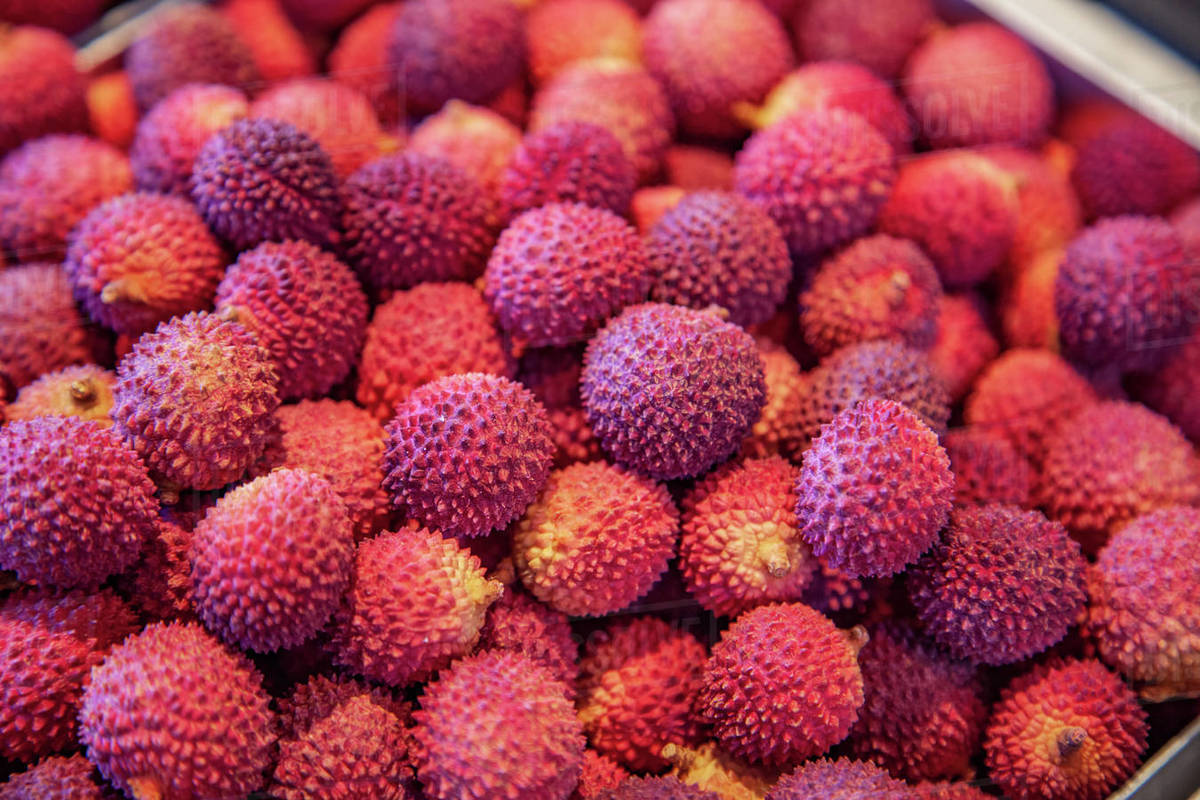 Selective focus of pile of lychees on blurred background - Stock Photo ...
