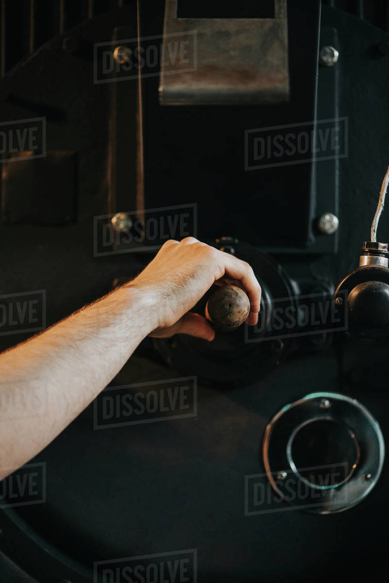 Male hand adjusting handle of machine for professional coffee ...