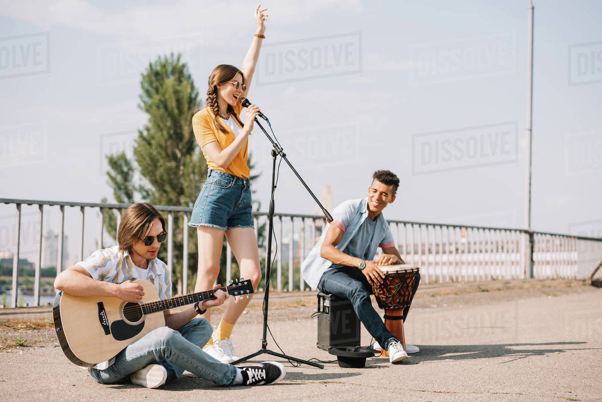 Multiracial young people performing singing on street - Royalty-free ...