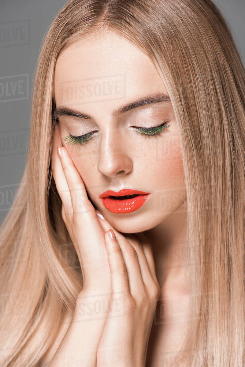 beautiful tender girl with long smooth hair looking down isolated on ...