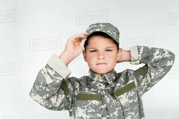 portrait of little kid in military uniform posing on grey background ...