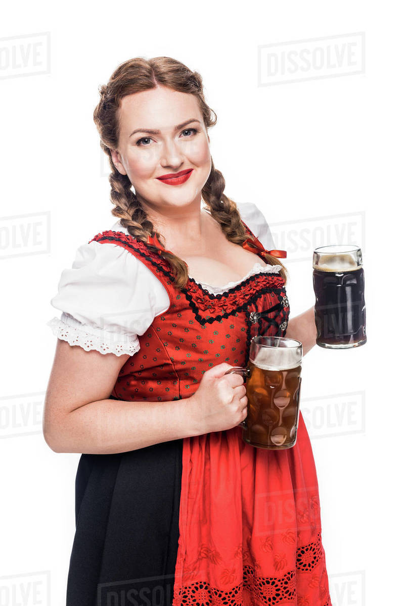 Happy oktoberfest waitress in traditional bavarian dress holding mugs ...