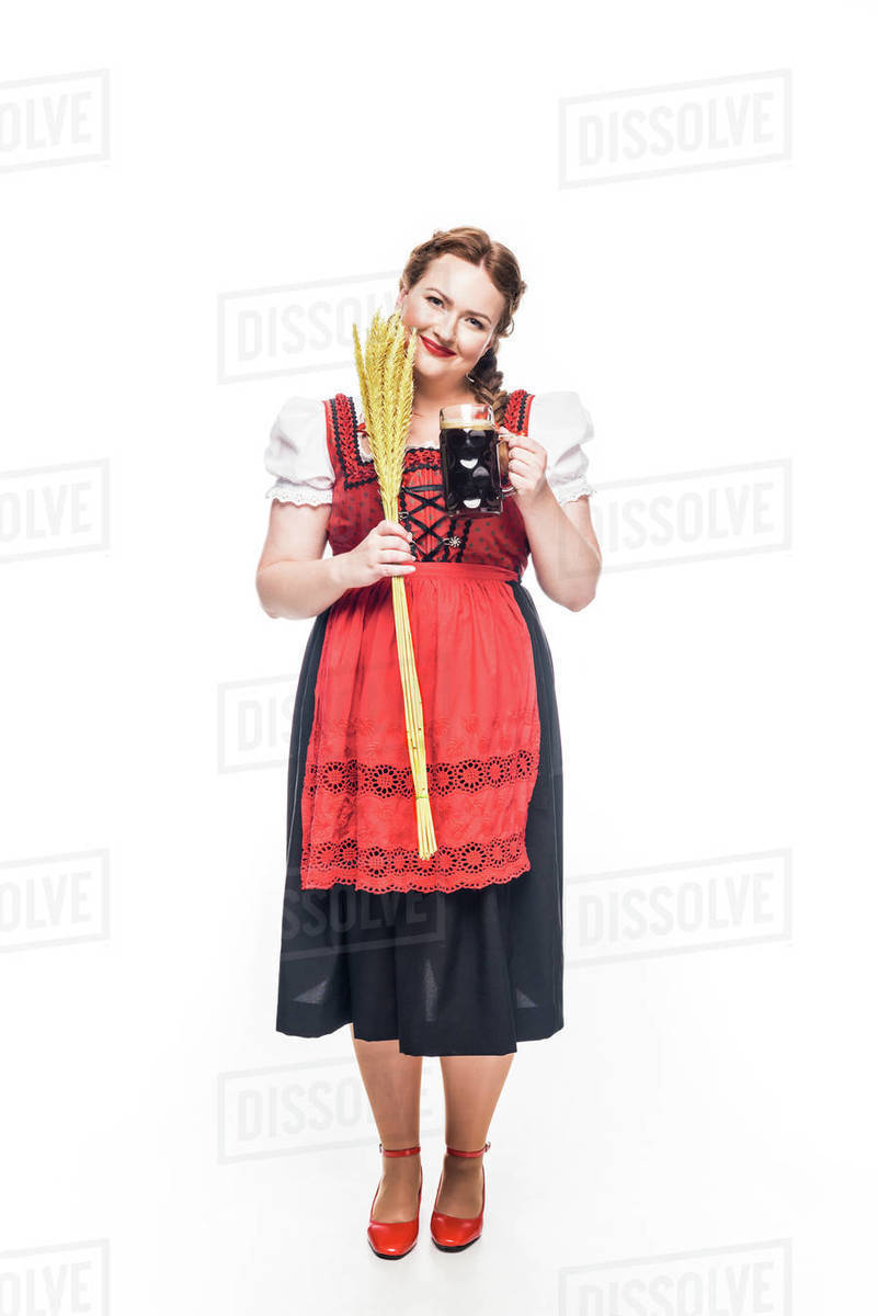 Happy oktoberfest waitress in traditional german dress holding wheat ...