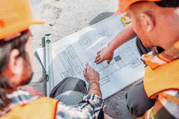 High angle view of builders pointing at blueprint - Royalty-free Stock ...