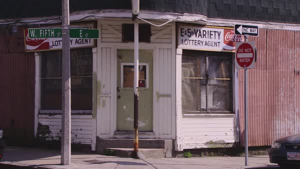 Boarded up old neighborhood variety store on the corner of Street E and ...