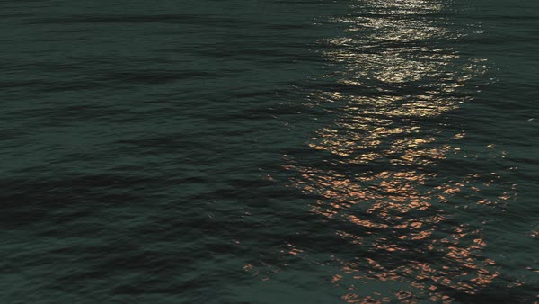 Expanse of dark unsettled water lit by faint distant source. - Stock ...