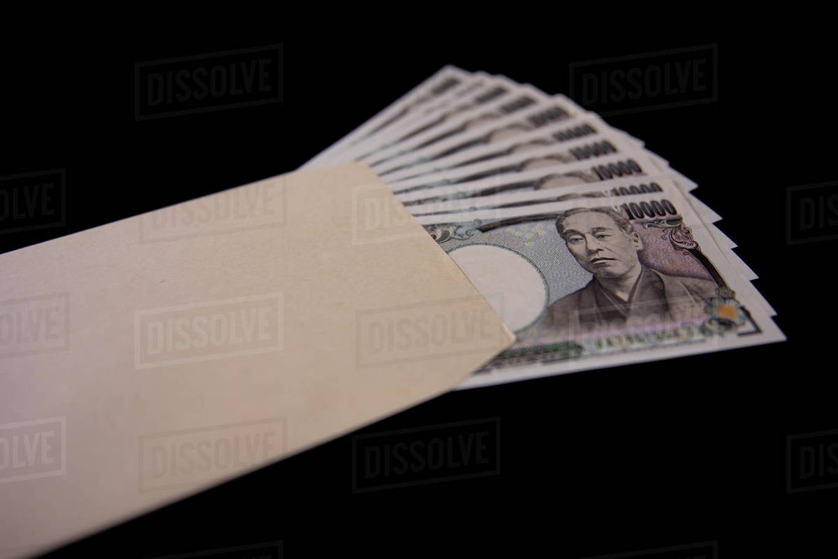 Japanese currency 100,000 yen with envelope on the black background ...
