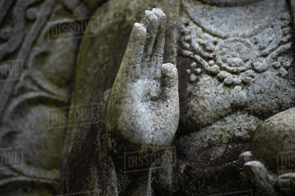 A religious stone statue of Jizo at Japanese buddhism temple - Royalty ...