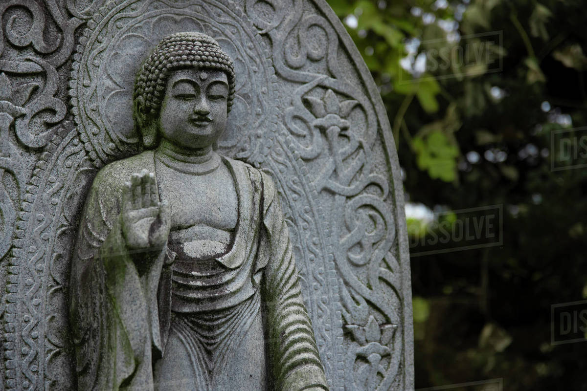 A religious stone statue of Shaka Nyorai at Japanese buddhism temple ...