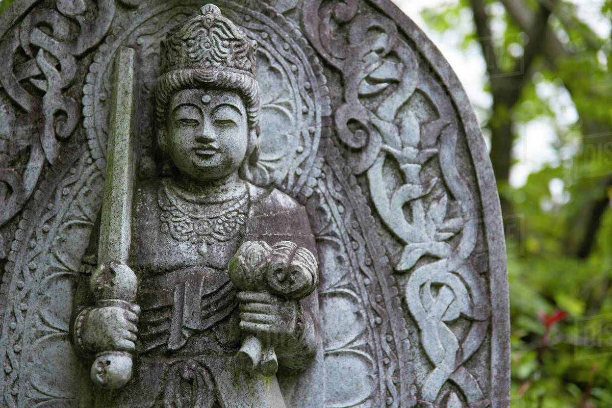 A religious stone statue of Akasagarbha at Japanese buddhism temple ...