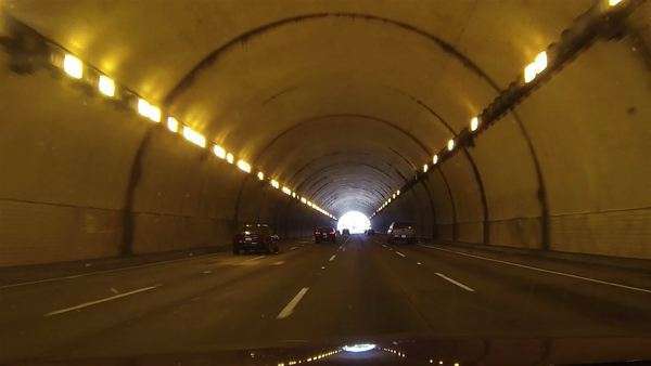 Driving through dark tunnel in car Point Of View. Driving through dark ...