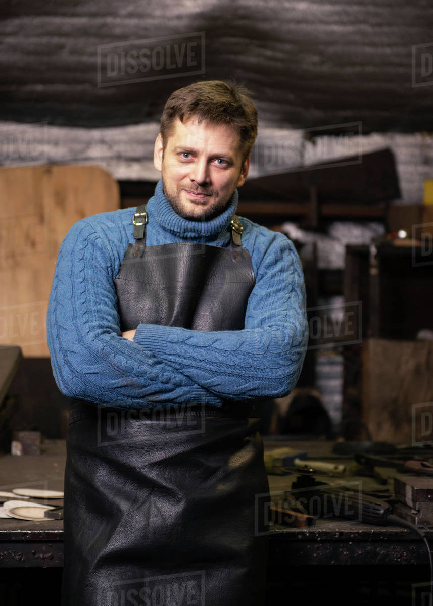Male blacksmith standing at work place looking at camera - Stock Photo ...