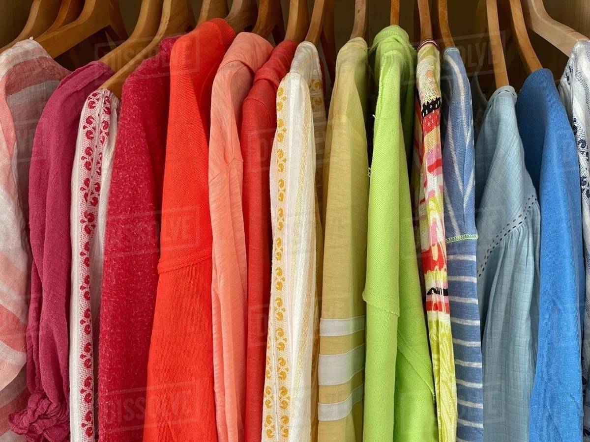 Close-up of a rainbow coloured clothes hanging in a wardrobe - Royalty ...