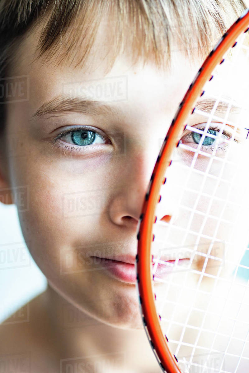 Boy holding a tennis racquet in front of his face - Royalty-free Stock ...