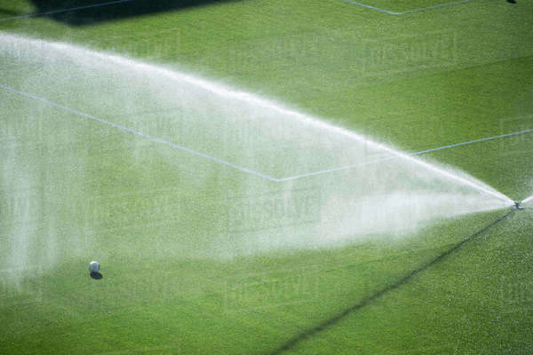 Overhead view of sprinklers watering a football pitch, Spain - Royalty ...