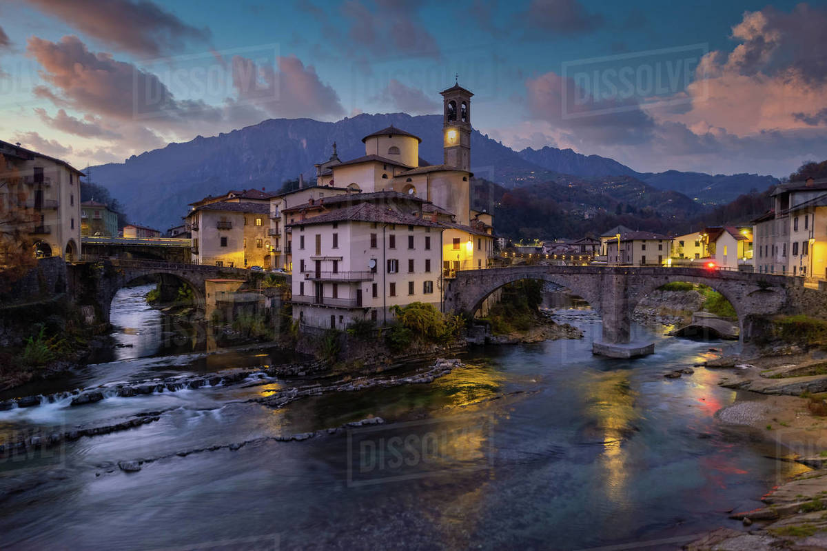 Aerial villagescape with mountain backdrop at night, San Giovanni ...