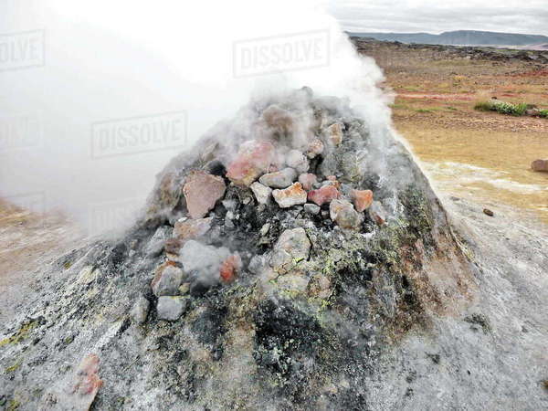 Close-up of steam coming out of a geothermal fumarole in summer ...