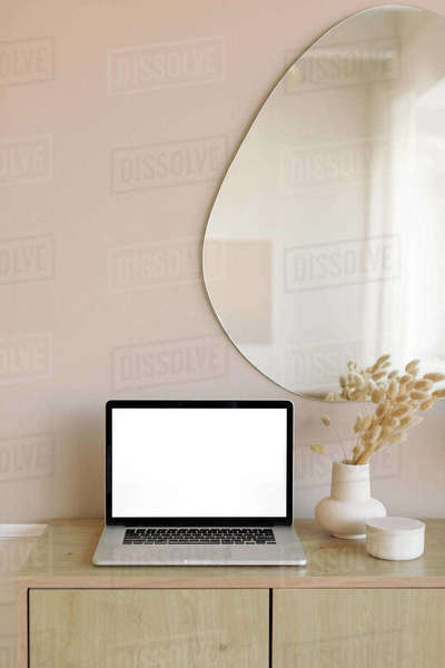 Open laptop computer with a blank screen on a sideboard in a living ...