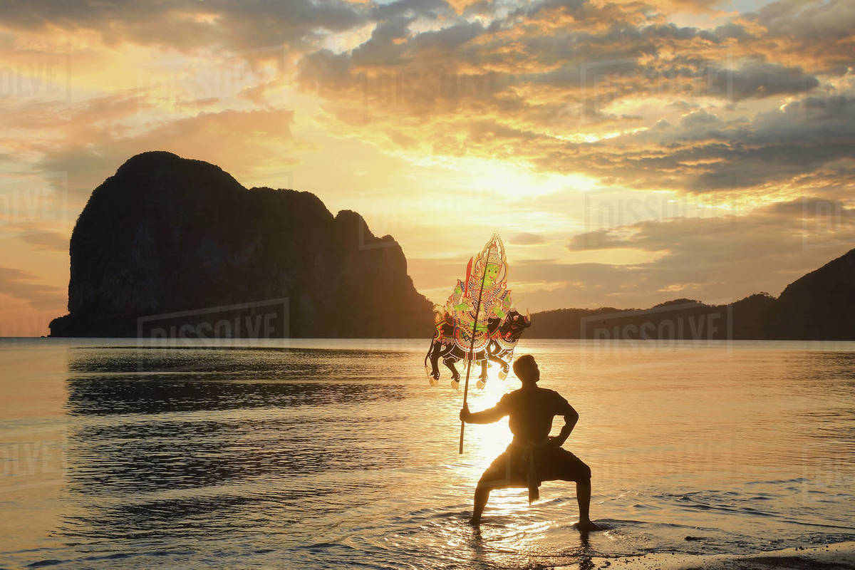 Silhouette of a man performing Traditional Thai Shadow Puppet Show on ...