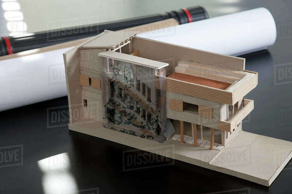 Plans and building model on table - Royalty-free Stock Photo | Dissolve