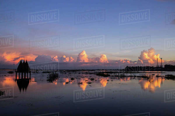 Clouds reflecting in water at sunset - Royalty-free Stock Photo | Dissolve