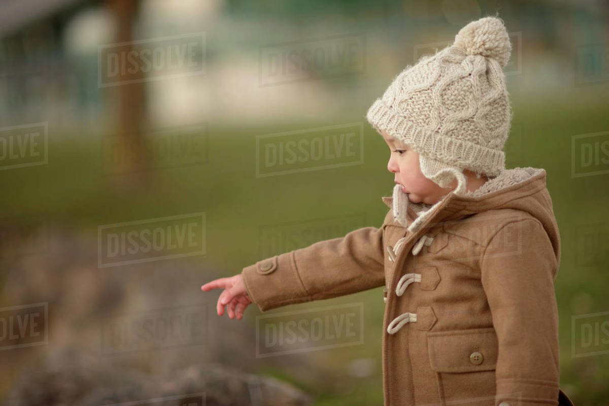 Side view of baby boy pointing - Royalty-free Stock Photo | Dissolve
