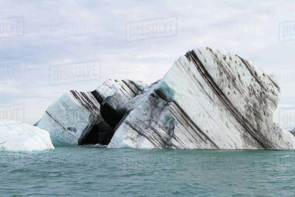 Black striped icebergs floating in Joekulsarlon lagoon, Iceland - Stock ...