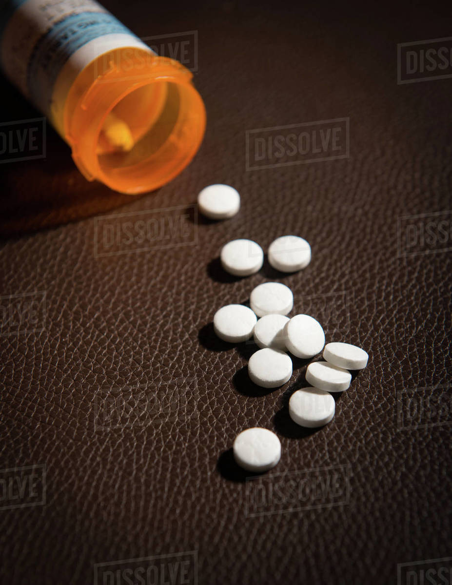 Prescription medication spilling out of a bottle - Royalty-free Stock ...