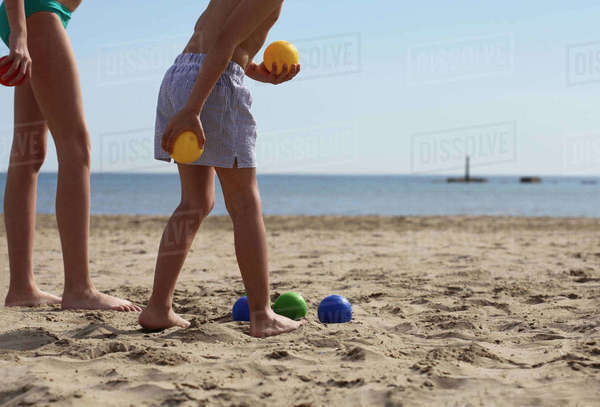 Boy and girl playing boules on the beach - Royalty-free Stock Photo ...