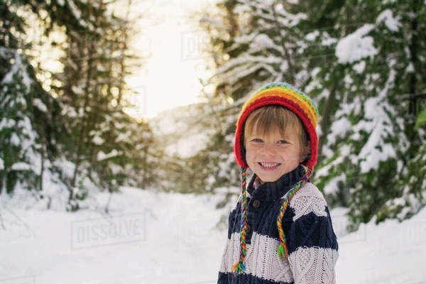Portrait of a smiling boy standing in snow - Royalty-free Stock Photo ...