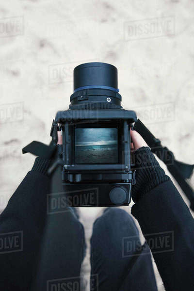 Woman using a medium format camera - Stock Photo - Dissolve