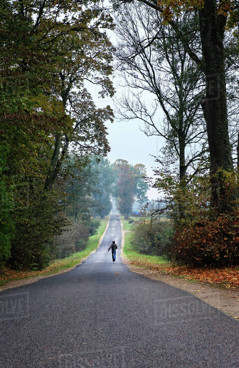 Man running down the road - Royalty-free Stock Photo | Dissolve