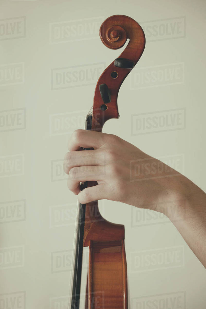 Girl's Hand holding violin - Royalty-free Stock Photo | Dissolve