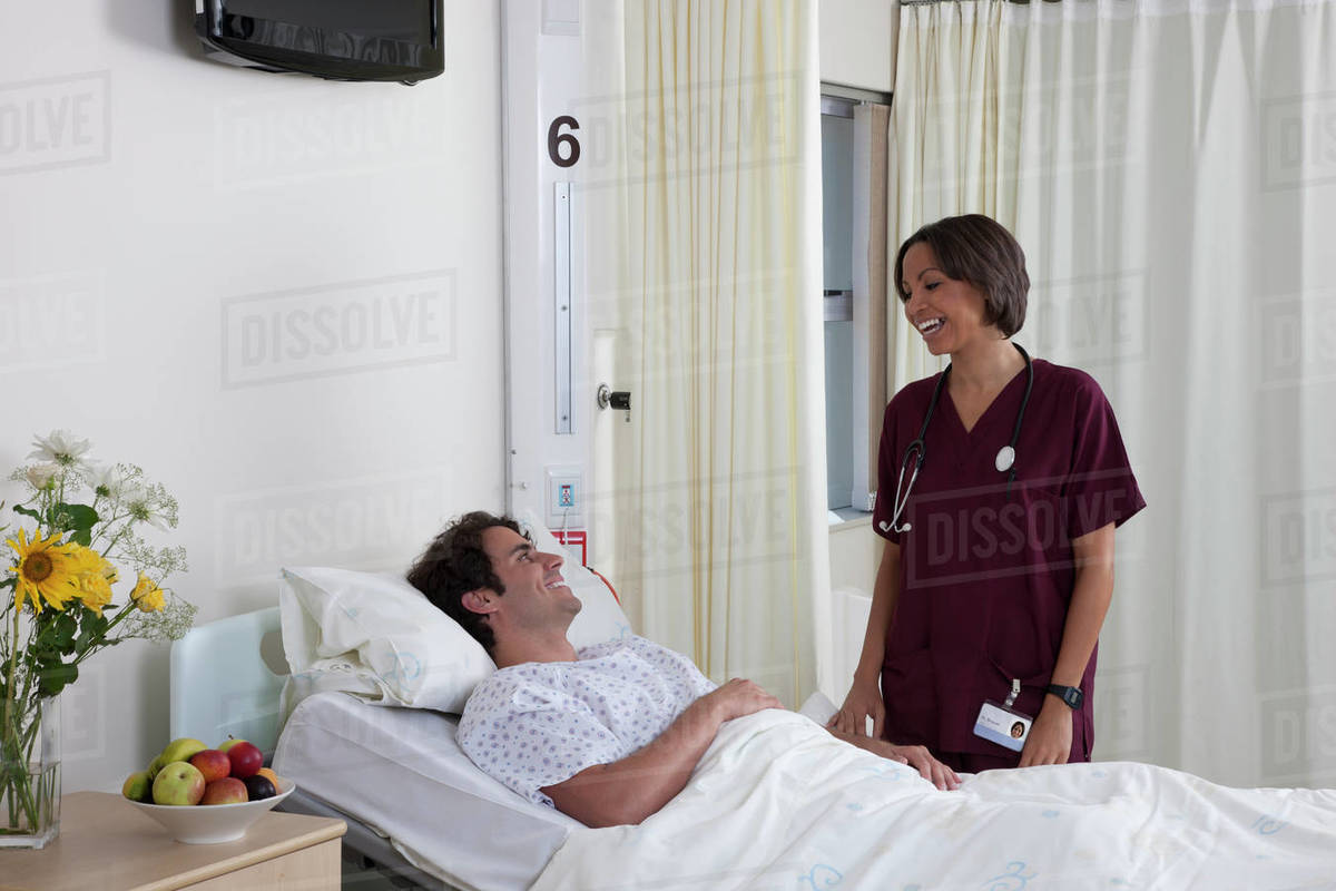 Hospital patient in bed talking with nurse - Royalty-free Stock Photo ...