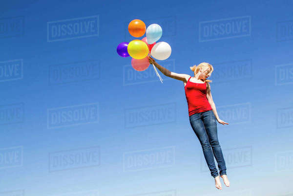Girl jumping with balloons - Royalty-free Stock Photo | Dissolve