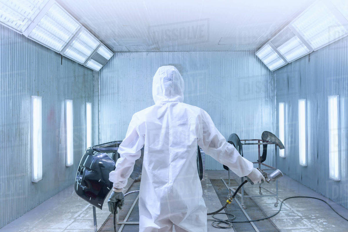 Mechanic respraying a car in a garage - Royalty-free Stock Photo | Dissolve