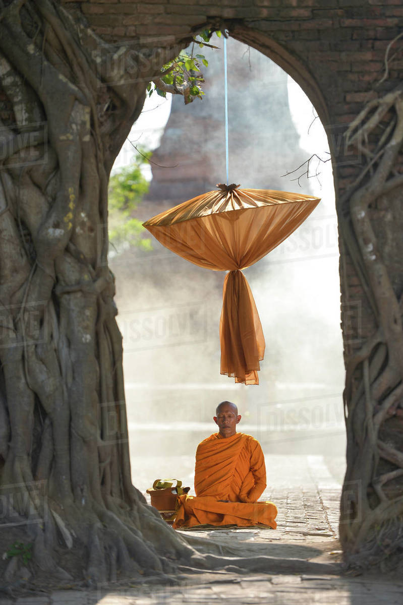Buddhist monk sitting in a temple meditating, Thailand - Royalty-free ...
