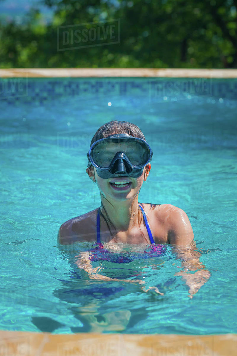Smiling girl wearing a scuba mask, in a swimming pool, Bulgaria ...