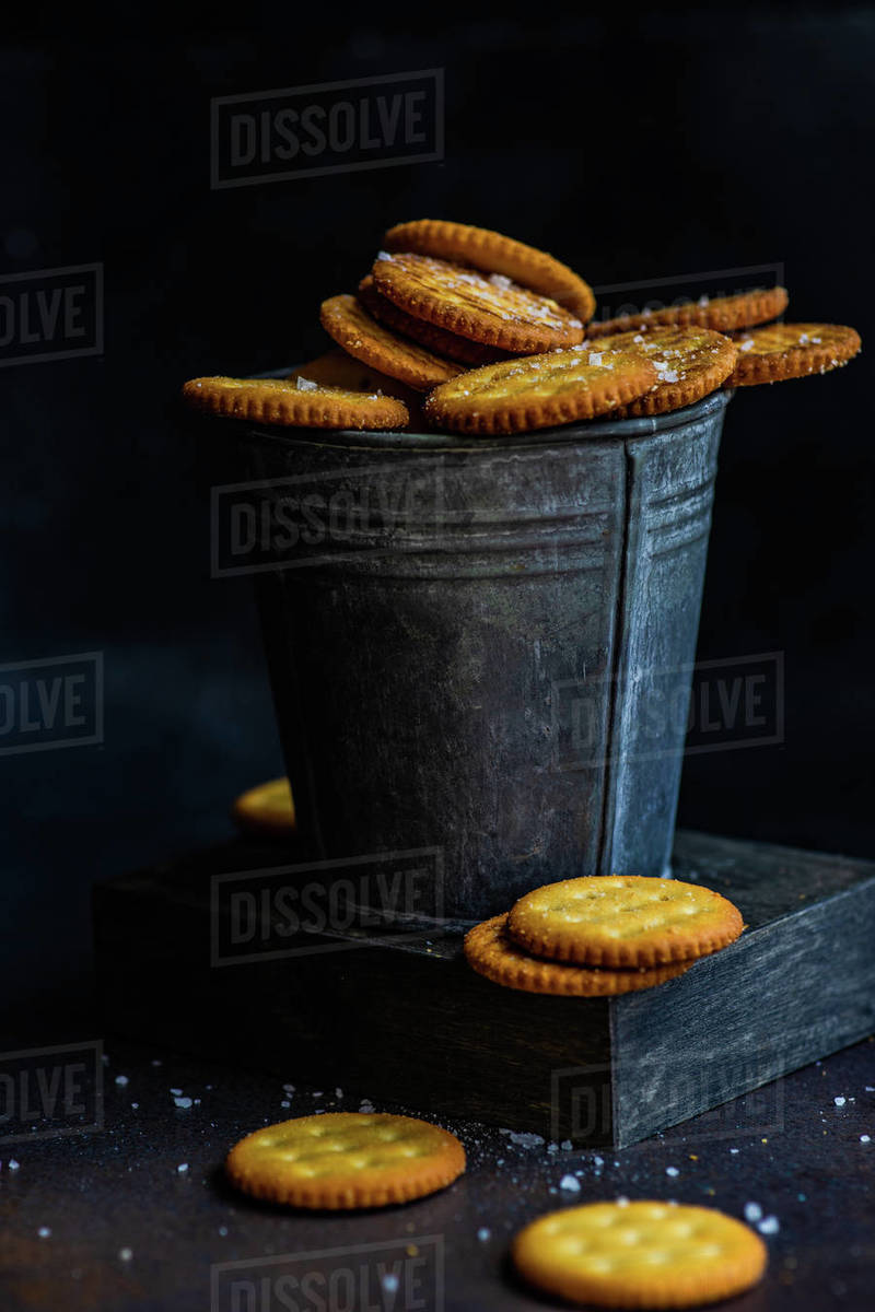 Salted cracker cookies in a metal bucket on a table - Royalty-free ...