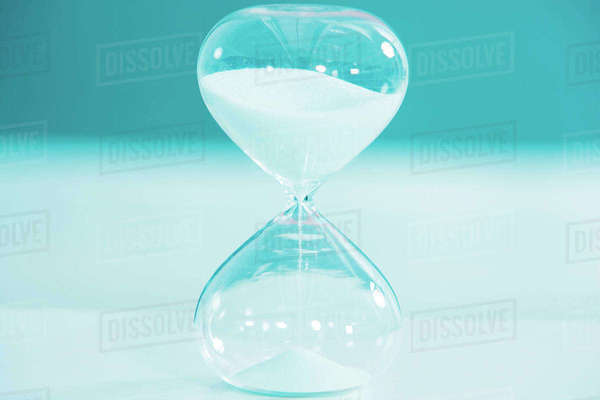 Hourglass sand timer in use - Stock Photo - Dissolve