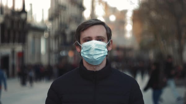 Young man wearing protective mask on street crowd people - 4K Royalty ...