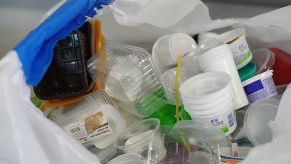 Close-up top view of package with various plastic waste sorting for ...