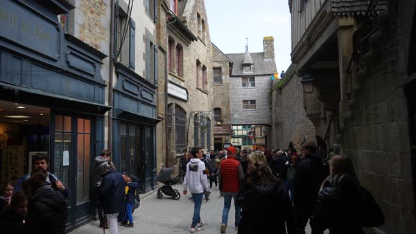 Mont-Saint-Michel, France - 3 May 2023. Crowd of multiethnic tourists ...