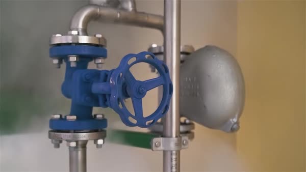 Hot steam leaks by pipe valve in production failure danger - Stock ...