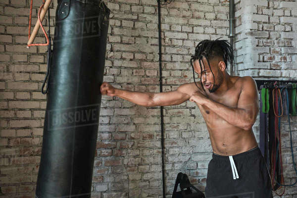 Black guy boxing in gym - Stock Photo - Dissolve